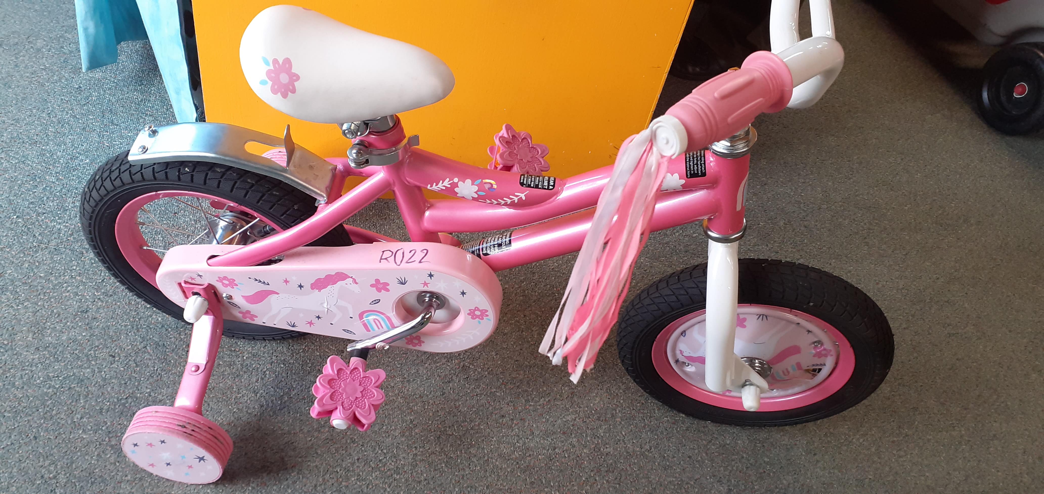Pink bike with training wheels